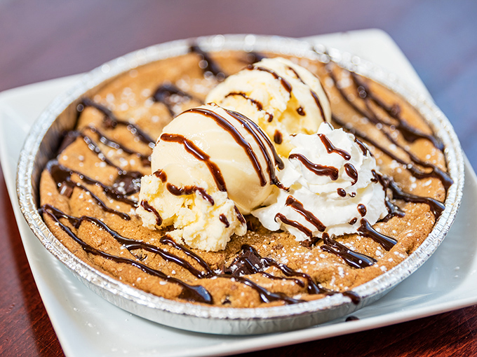 This cookie skillet dessert isn't just breaking diet plans—it's obliterating them with warm, gooey chocolate and cold ice cream in perfect harmony. 
