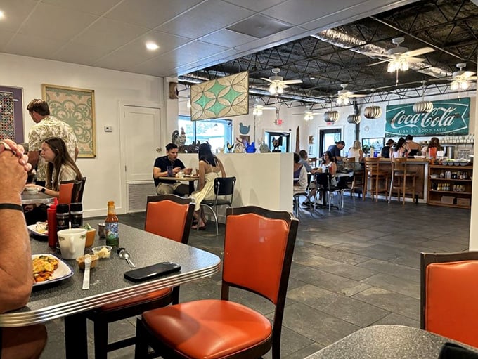 Not just a dining room—it's a breakfast theater where the orange chairs invite you to take a front-row seat to the most important meal.