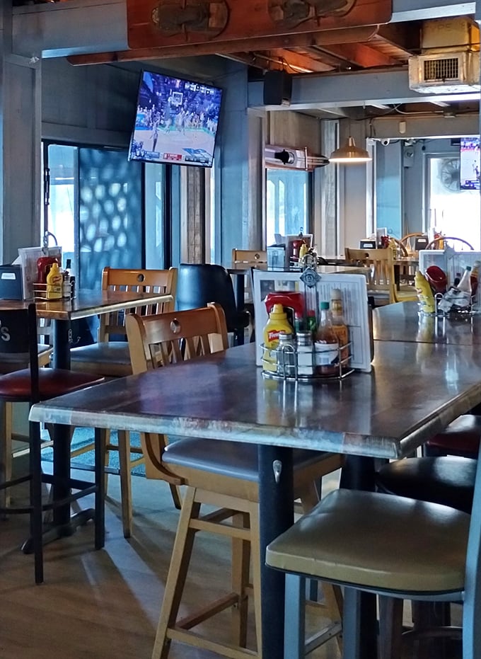 Metal tables, wooden chairs, and condiment caddies—the universal language of "we care more about our food than our furniture," and I'm here for it.