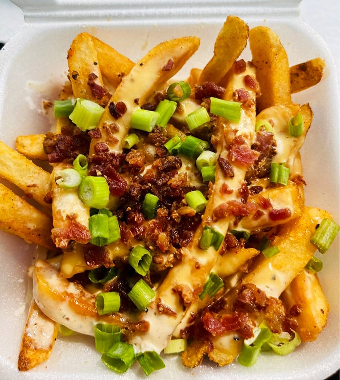 Dirty fries that make you question your upbringing—where was this combination of cheese, bacon, and green onions when you were growing up?