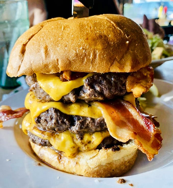 This towering bacon cheeseburger doesn't just satisfy hunger – it conquers it, plants a flag, and claims victory in the name of deliciousness.