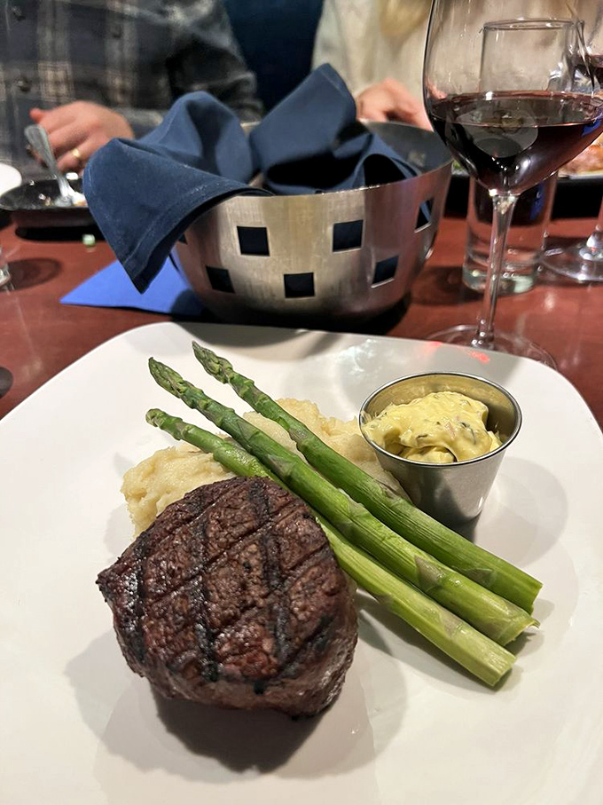 A perfectly seared filet with asparagus spears standing at attention. This isn't just steak—it's meat mathematics solved to perfection.