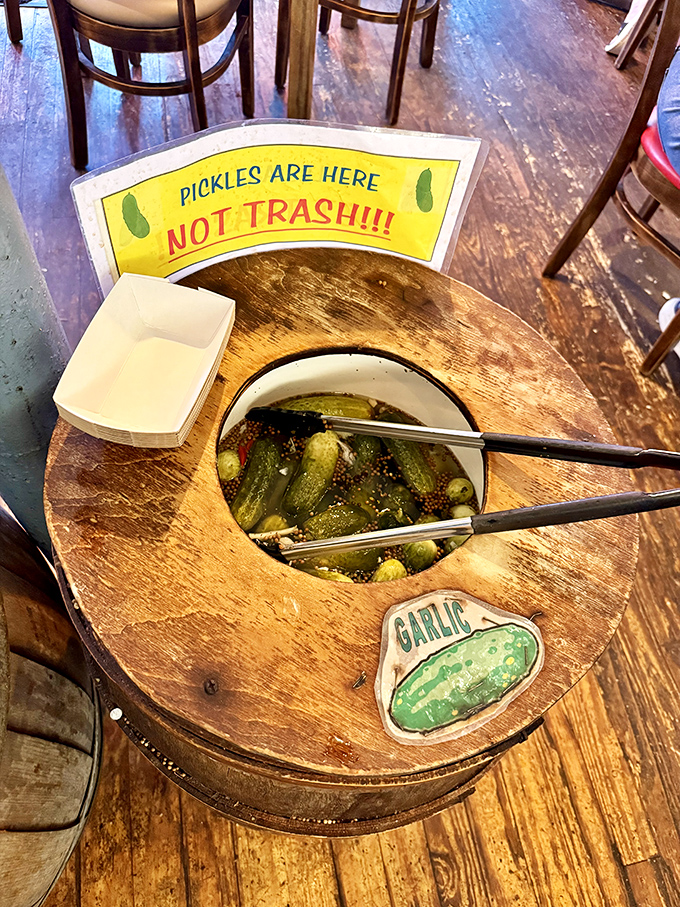 PICKLES ARE HERE NOT TRASH!!! declares the sign above the barrel—perhaps the most passionate pickle advocacy you'll ever encounter.