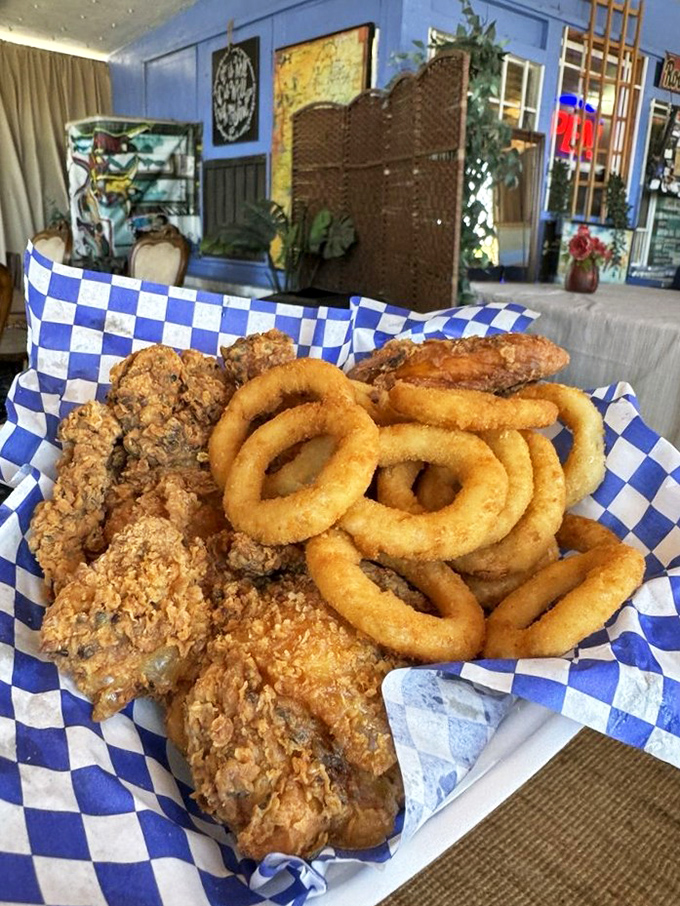 Crispy fried chicken and golden onion rings—proof that sometimes the simplest pleasures are the most profound. No filter needed.