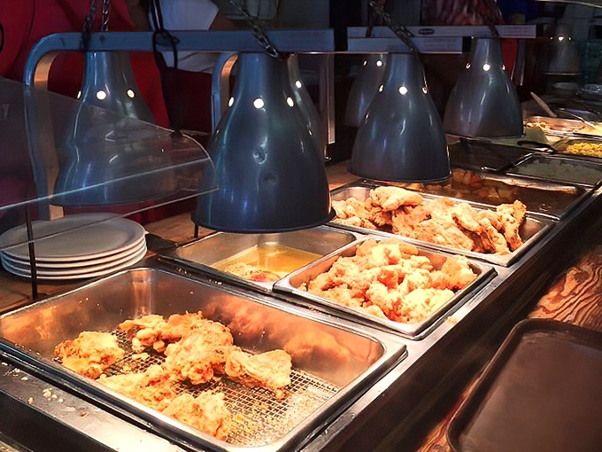 Fried chicken under heat lamps – not just food, but edible sunshine that makes you understand why people cross county lines for lunch.