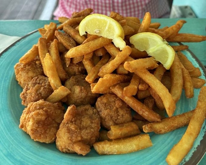 Golden-fried scallops and fries with lemon wedges—simple perfection that needs no explanation, just appreciation. And maybe a cold beer.