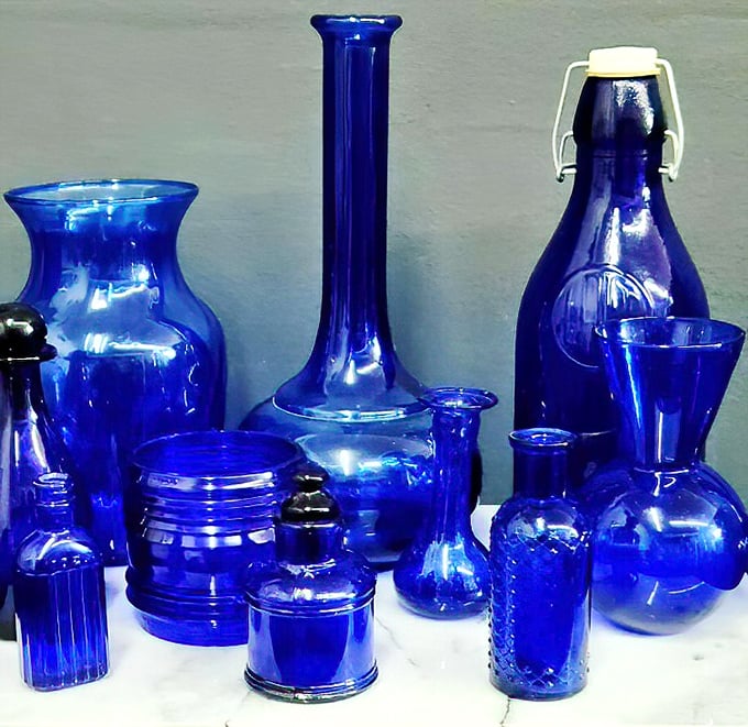 A symphony in cobalt blue—these glass pieces aren't just vessels; they're instant mood-lifters that transform ordinary shelves into art installations.