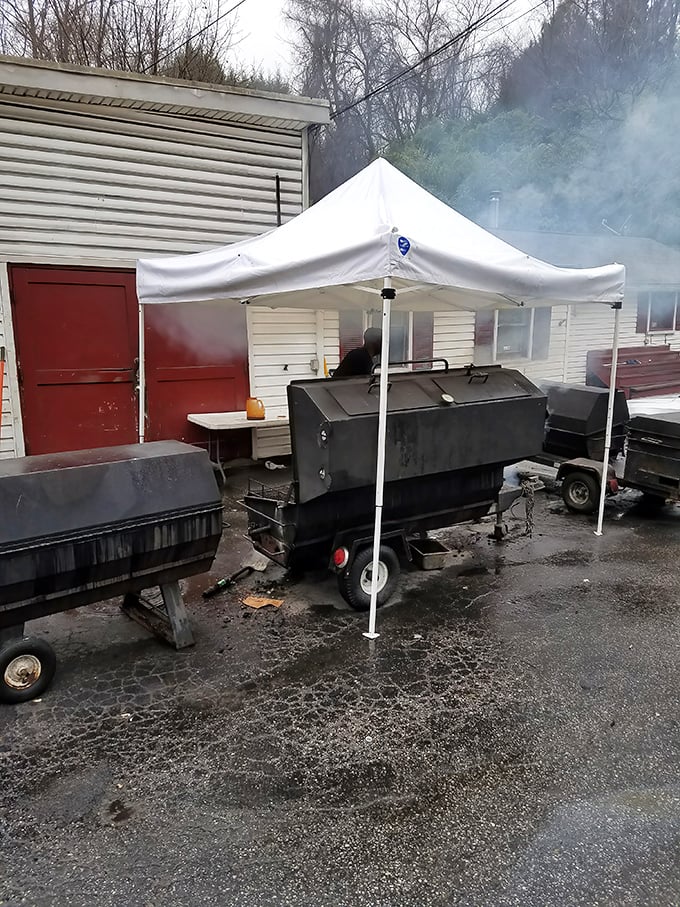 The beating heart of Jake's operation – where smoke billows like gentle clouds and pitmasters work with the focus of brain surgeons.