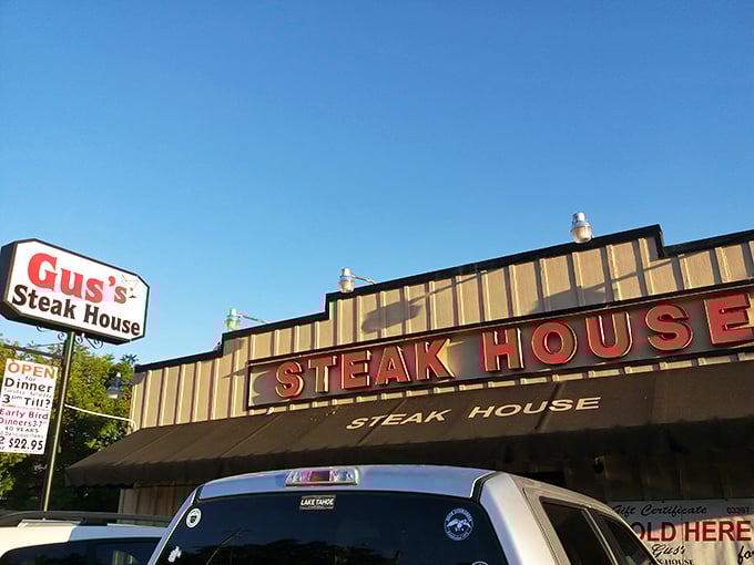 Gus's Steakhouse promises the kind of meal that makes vegetarians temporarily question their life choices—just look at that sign!