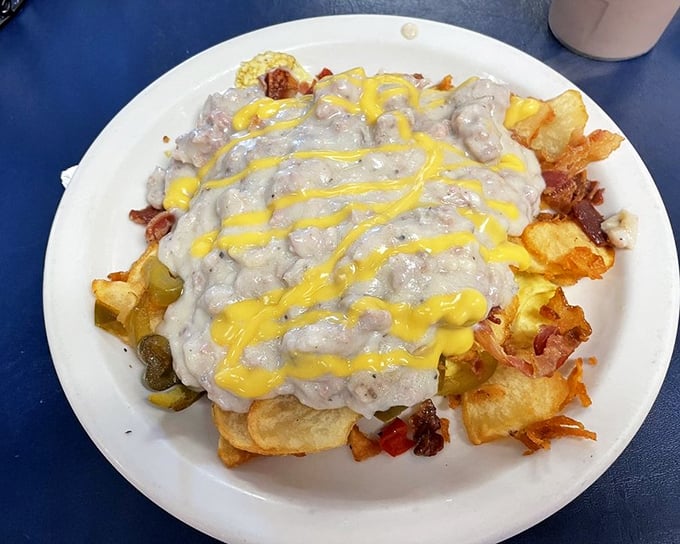 The "Haystack"—where breakfast meets architectural ambition. A foundation of potatoes crowned with country gravy and a sunshine drizzle of cheese.