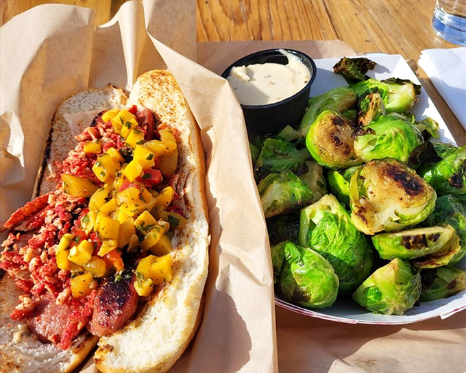 A sandwich that demands to be photographed before eaten, paired with Brussels sprouts that might convert even the most dedicated vegetable skeptics.
