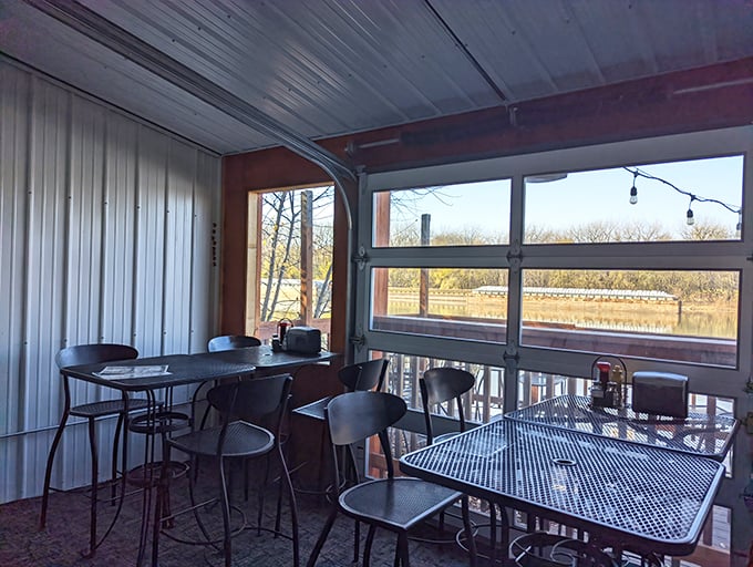 The riverside dining room offers panoramic water views through garage-style doors—bringing the outside in and making every table feel like the best seat in the house.
