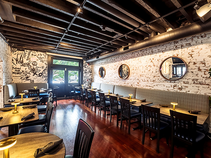 Exposed brick walls tell stories while wooden tables await yours. This dining room doesn't just serve food—it hosts moments.