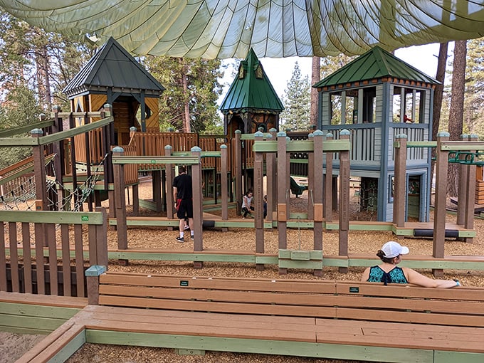 This woodland playground looks like it was designed by elves with advanced degrees in childhood development and forest aesthetics.