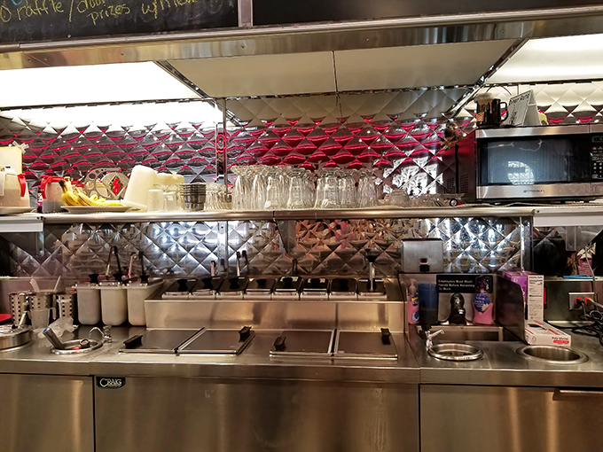 The gleaming stainless steel kitchen—where breakfast magic happens all day long behind a choreographed dance of spatulas and sizzle.