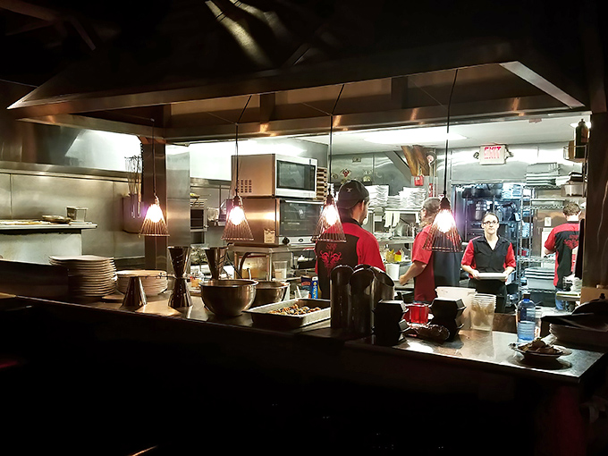 The kitchen's choreographed chaos reveals the secret behind every perfect plate—a team moving with the precision of a culinary ballet.