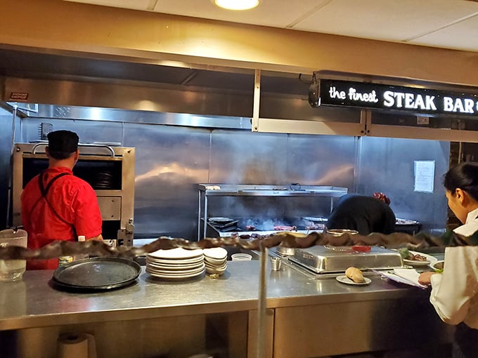 A glimpse into the kitchen reveals the heart of the operation—where "the finest STEAK BAR" isn't just a sign, it's a promise.