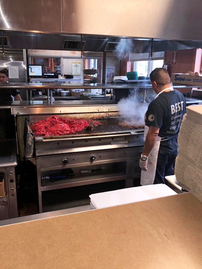 Where the magic happens—a glimpse into the kitchen reveals the choreographed dance of sandwich creation in full swing.