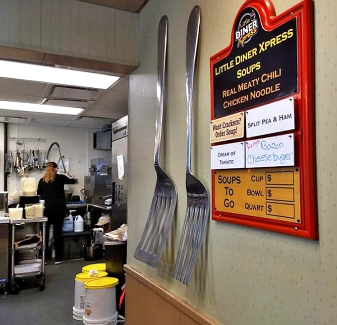 Giant decorative forks flank a soup menu – a playful reminder that serious eating happens here, and they've got the oversized utensils to prove it.
