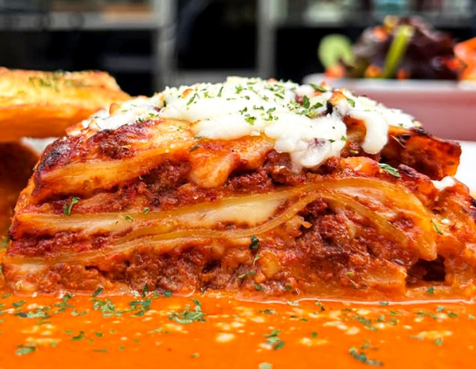 Lasagna with layers that deserve their own geological study—each one revealing a new reason to postpone your diet until tomorrow.