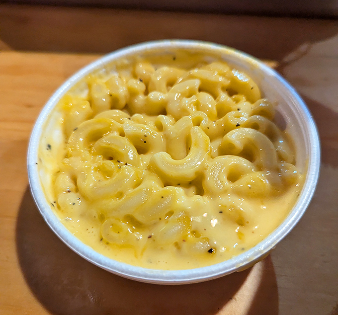 This mac and cheese isn't just a side dish—it's a creamy lifeboat in a sea of spice, offering momentary refuge between bites of fire.