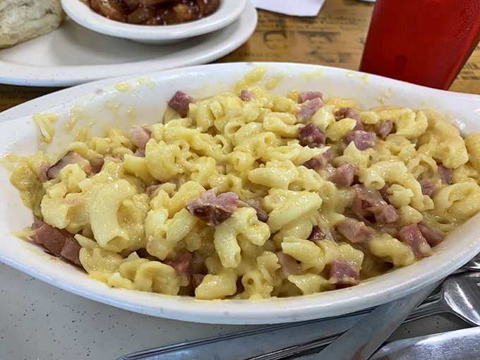 Mac and cheese with ham chunks that would make a Parisian chef question their life choices. Comfort food that speaks the universal language.