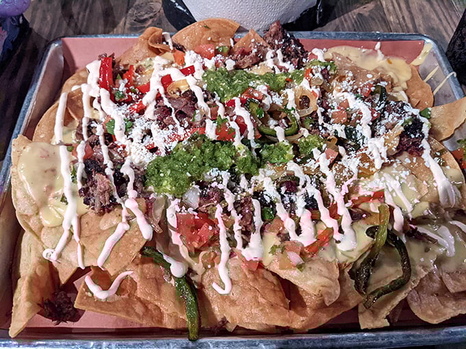 These aren't just nachos—they're an architectural marvel of chips, cheese, meat, and toppings that somehow maintains structural integrity until the last bite.
