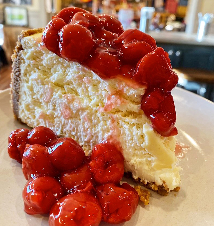 This cheesecake, crowned with ruby cherries, isn't just dessert—it's the grand finale your taste buds have been waiting for.