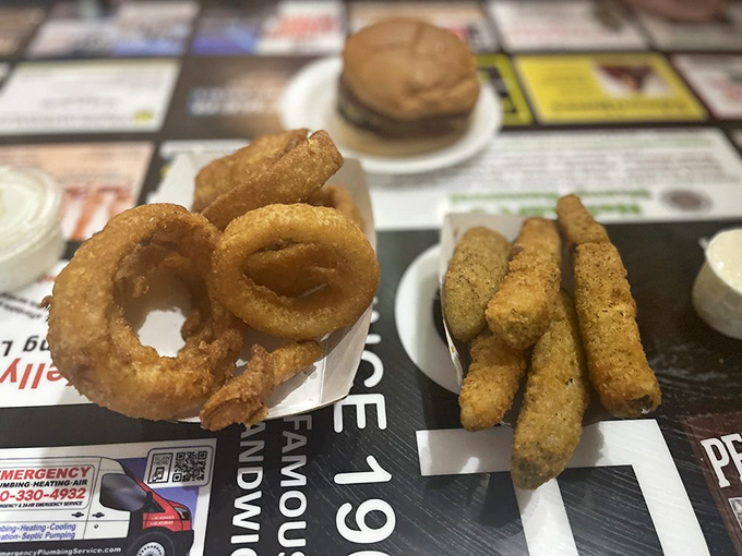Supporting actors that deserve their own spotlight—perfectly crisp onion rings and golden fried pickles that refuse to be mere side characters.