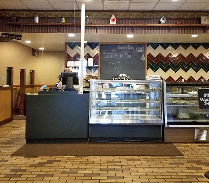 The ordering counter, where dessert displays remind you to save room – or simply start with dessert. Life's uncertain, after all.