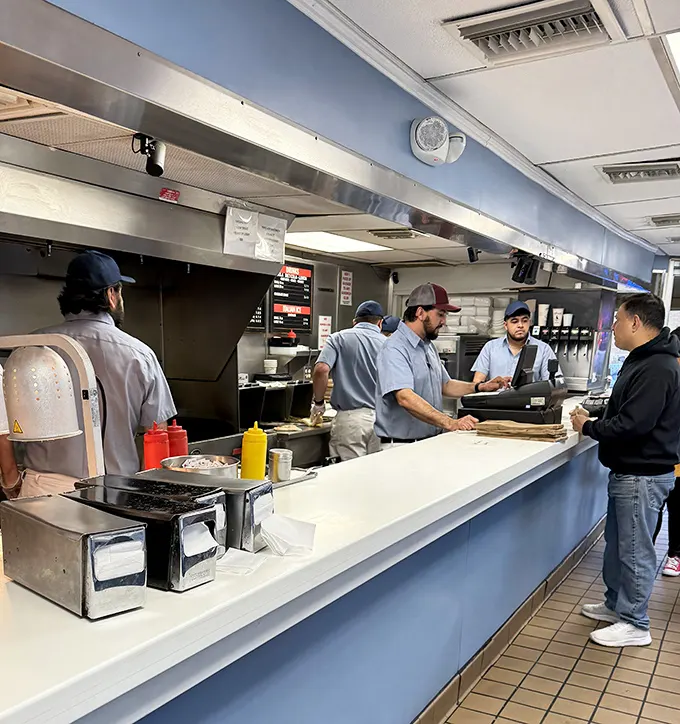 The counter—where dreams become reality and decisions have delicious consequences. Order confidently or risk the collective sighs of Chicago.