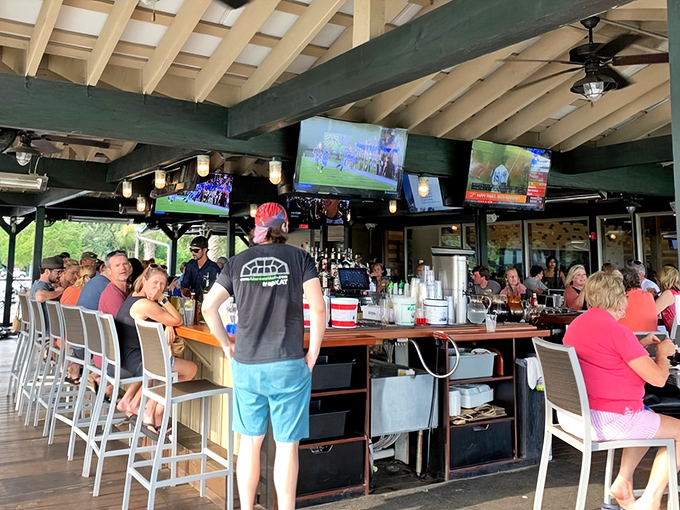 The outdoor bar—where watching sports meets watching boats, and nobody's checking their email. Paradise found.