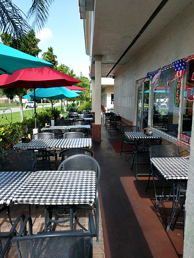 Florida sunshine meets diner charm on the patio, where checkered tablecloths flutter in the breeze like flags of delicious surrender.
