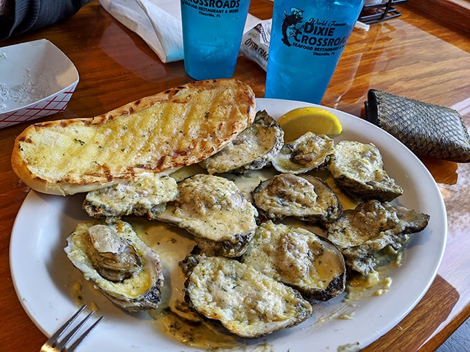 These oysters aren't just served—they're presented with the reverence they deserve, alongside garlic bread that's begging to soak up every last drop.