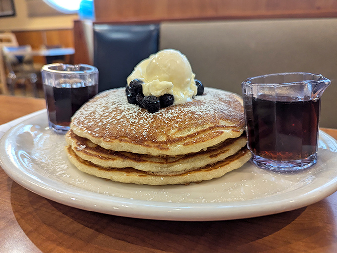 These pancakes achieve that mythical balance—fluffy enough to impress, substantial enough to satisfy—topped with berries and powdered sugar snow.