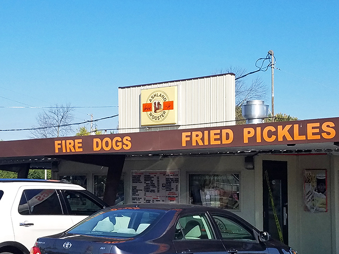 "FIRE DOGS" and "FRIED PICKLES" announce themselves in no-nonsense lettering. This place doesn't need Instagram filters—it's authentically itself.