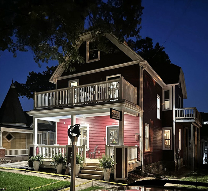 This charming Victorian home glows with after-dark promise, like the setting for a Hallmark movie where everyone finds love over locally-sourced appetizers.