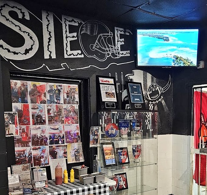 The wall of fame showcases local sports pride and customer memories—a community scrapbook seasoned with ketchup and nostalgia.