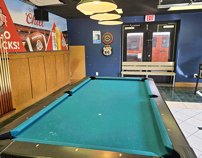 The pool table stands ready for friendly competition—because nothing builds an appetite for pizza like the sound of breaking balls.