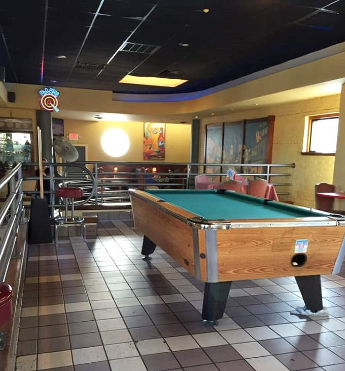 The pool table area provides that essential "third space" between restaurant and bar—where friendships are formed over friendly competition and shared appetizers.