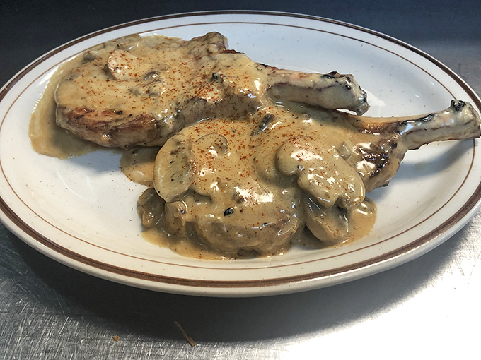Pork chops swimming in mushroom gravy—a plate that whispers "Sunday dinner at grandma's" with every savory bite.