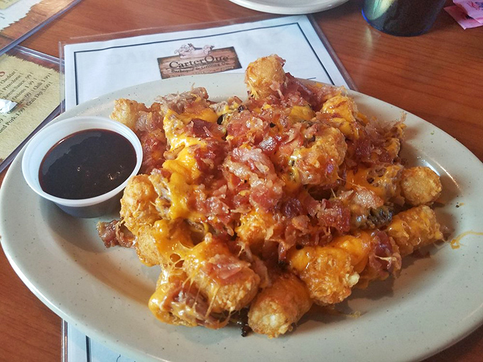 Tater tots elevated to art form – crispy potato nuggets crowned with cheese, bacon and pulled pork. Comfort food having its finest moment.