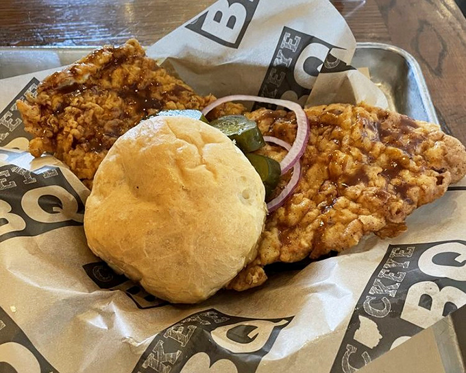 A crispy tenderloin sandwich that's practically bursting from its bun, like the overachiever at the barbecue prom.