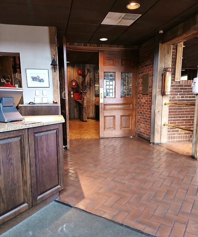 The entrance sets the tone immediately – brick, wood, and the lingering promise of hickory smoke welcomes you home.