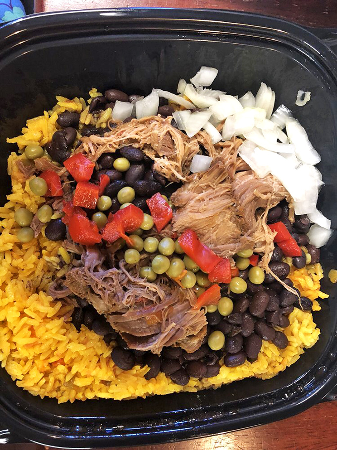 This isn't just rice and beans—it's a canvas where tender pork, peppers, and onions create an edible masterpiece that puts fancy plating to shame.