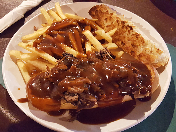 Gravy cascades over tender roast beef like Niagara Falls' delicious cousin. This isn't just a sandwich—it's a savory waterfall on a plate.