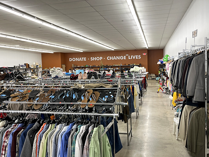 "DONATE · SHOP · CHANGE LIVES" says it all. Racks of possibility stretch before you in this fashion treasure hunt with purpose.