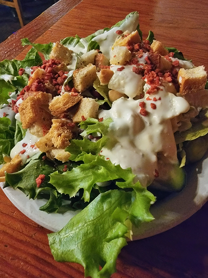 A salad that knows its purpose: to provide a brief, crisp interlude before the main event. Those bacon bits aren't just toppings—they're tiny ambassadors of flavor.