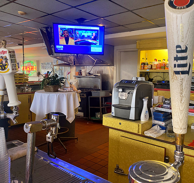 The bar area blends old-school charm with modern conveniences—where classic cocktails meet sports on TV in perfect harmony.