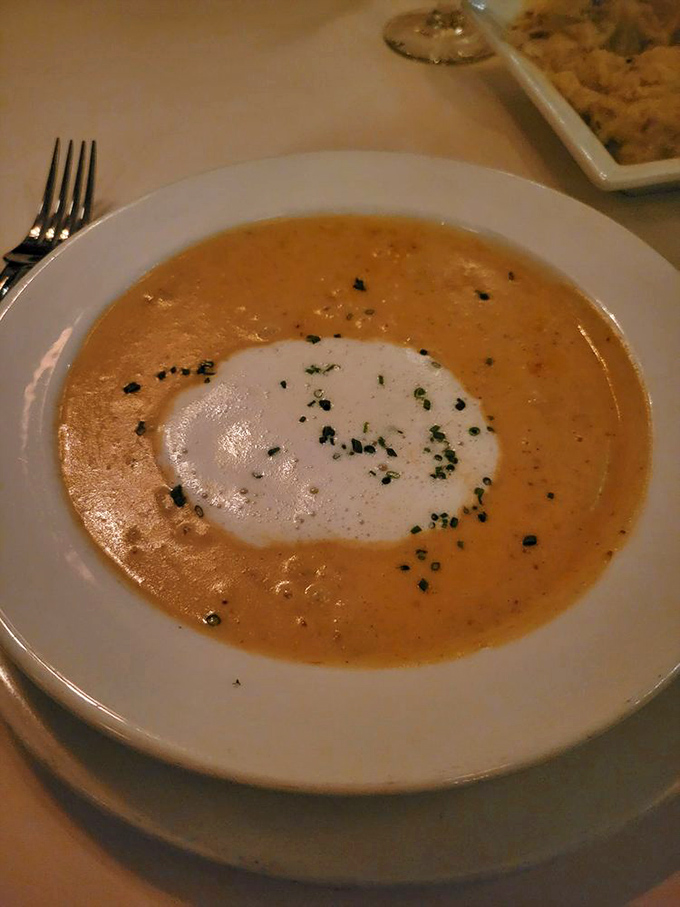 She-crab soup, crowned with a dollop of cream – Charleston's liquid legacy served with the kind of presentation that makes you pause before diving in.